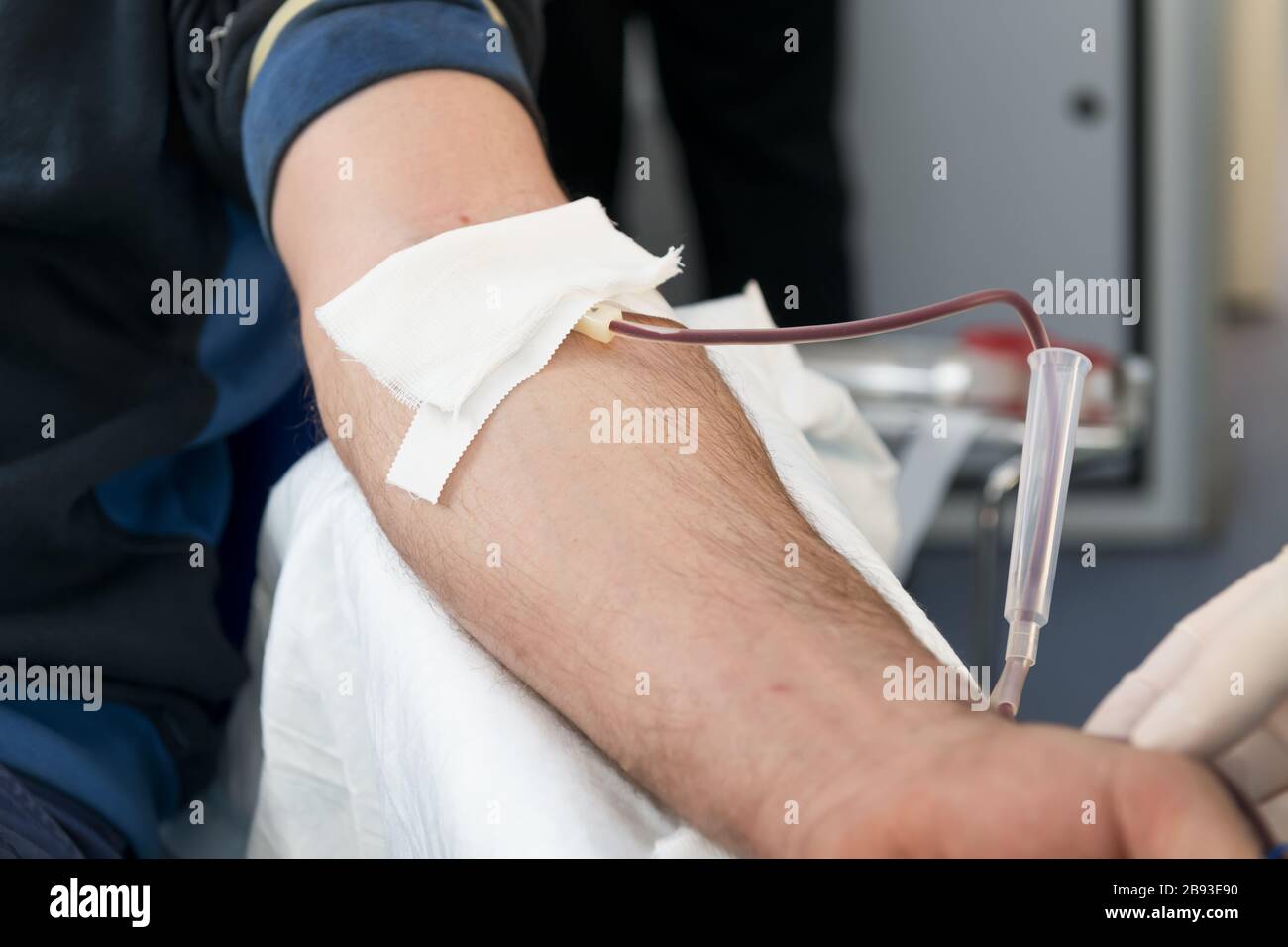 Close up arm of a man who donates blood. Male donor gives blood in a ...