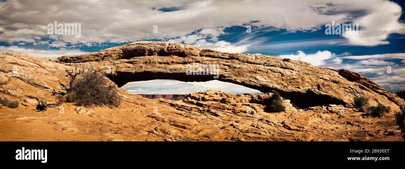 Natural arch created in eroded rock formations in a rural landscape ...