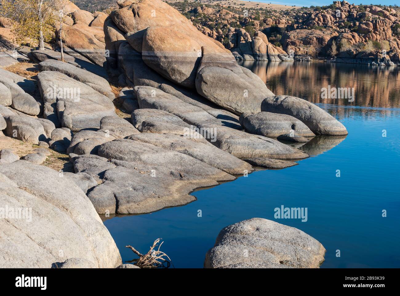 Landscape of brown and tan rock formations at water at Watson Lake Park ...