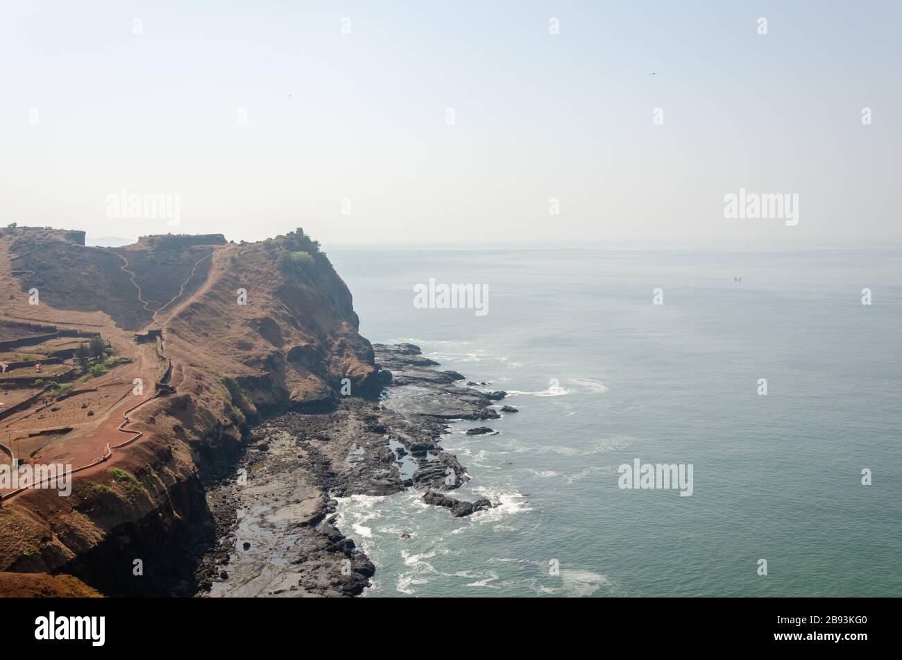 View of the shoreline and road which leads up to the Ratnadurg Fort, Ratnagiri, Maharashtra ...