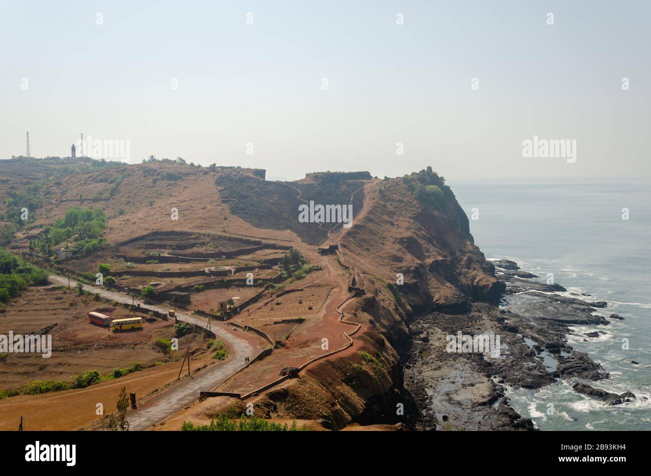 View of the shoreline and road which leads up to the Ratnadurg Fort, Ratnagiri, Maharashtra ...