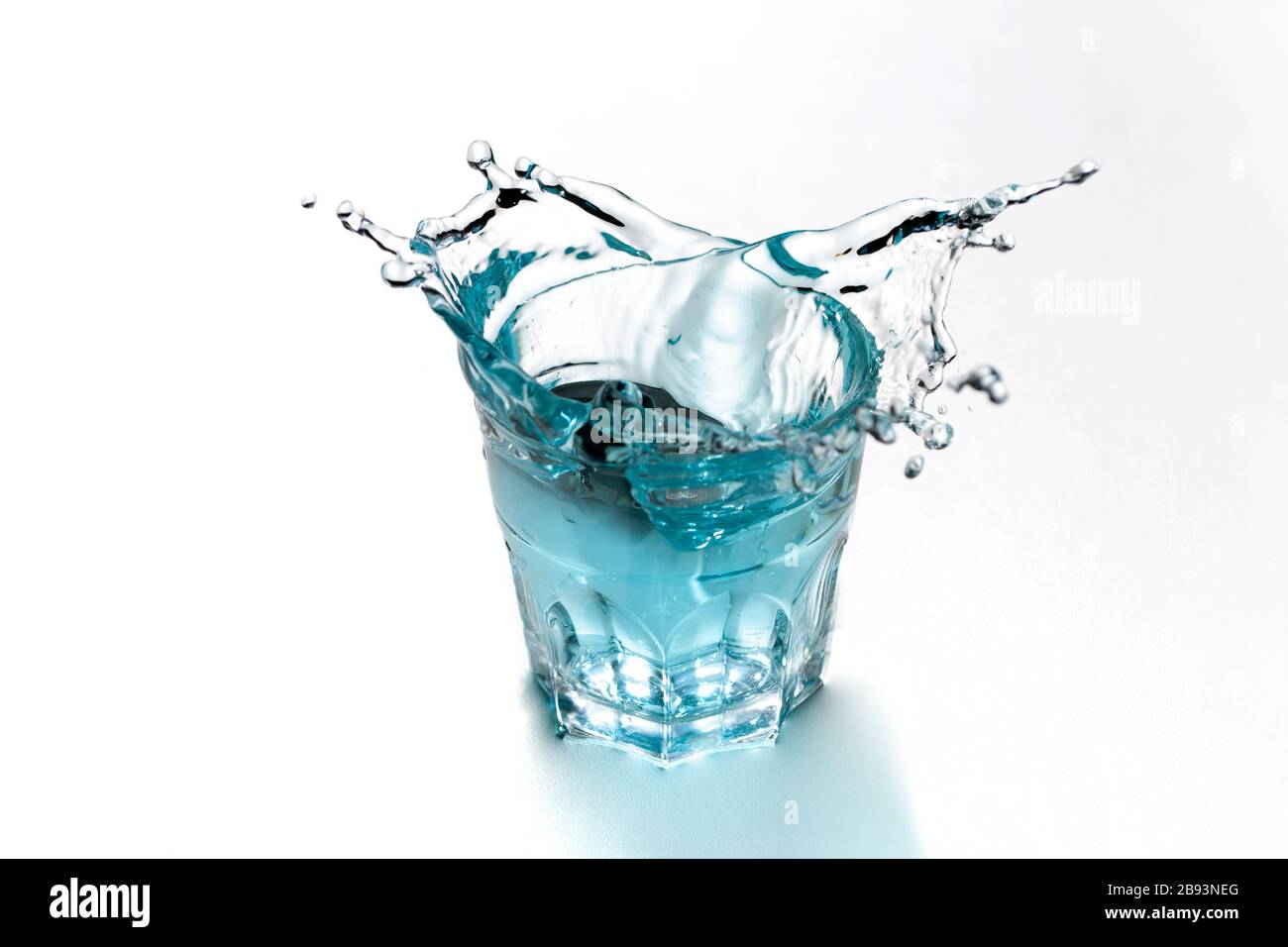 Blue water splashing in transparent glass. Refreshing drink Stock Photo ...