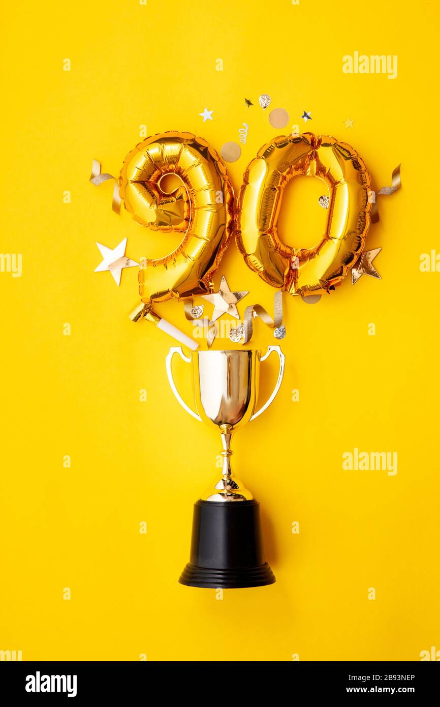 Number 90 gold anniversary celebration balloon exploding from a winning ...