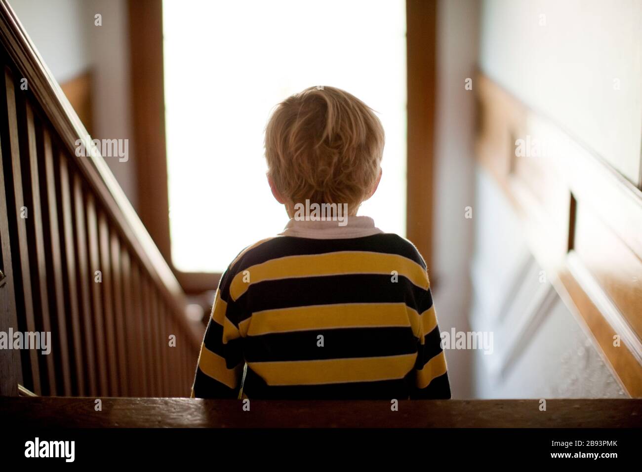 Little boy sitting on stairs Stock Photo - Alamy