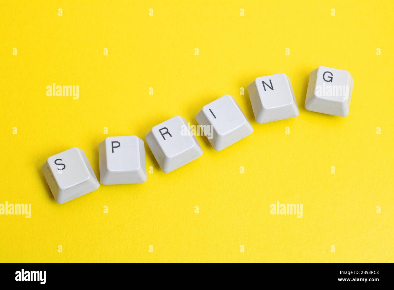 Word spring made of keyboard keys on yellow background Stock Photo - Alamy