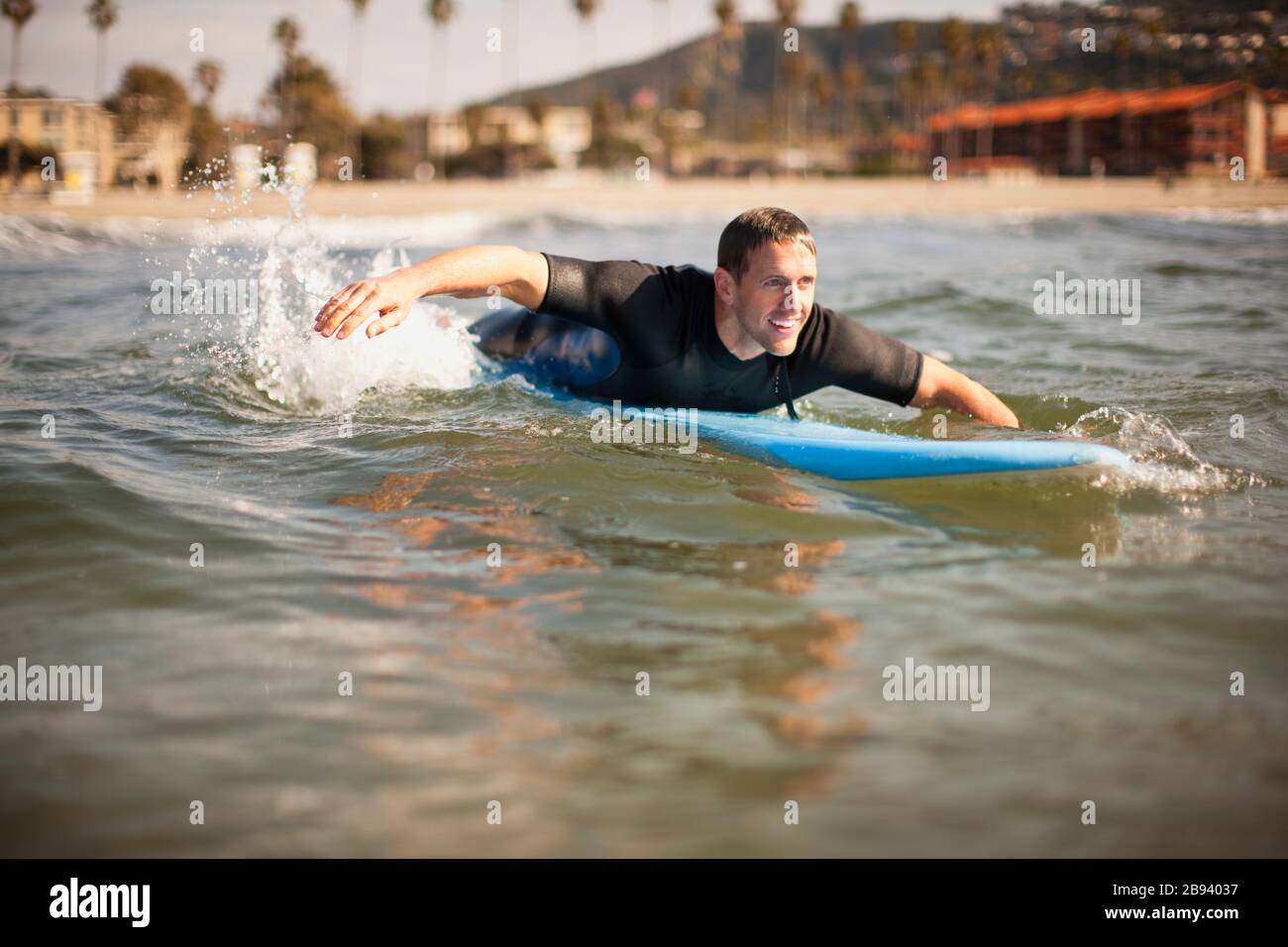 Surfers paddling on surfboards hi-res stock photography and images - Alamy