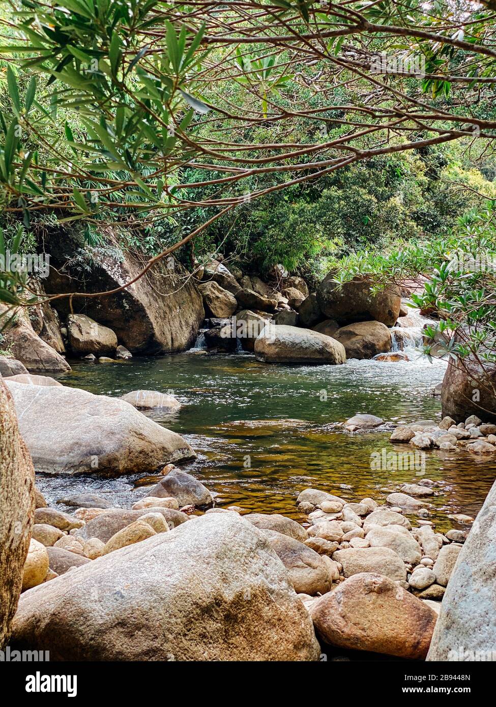 A small mountain river flows among large stones in mountainous areas ...
