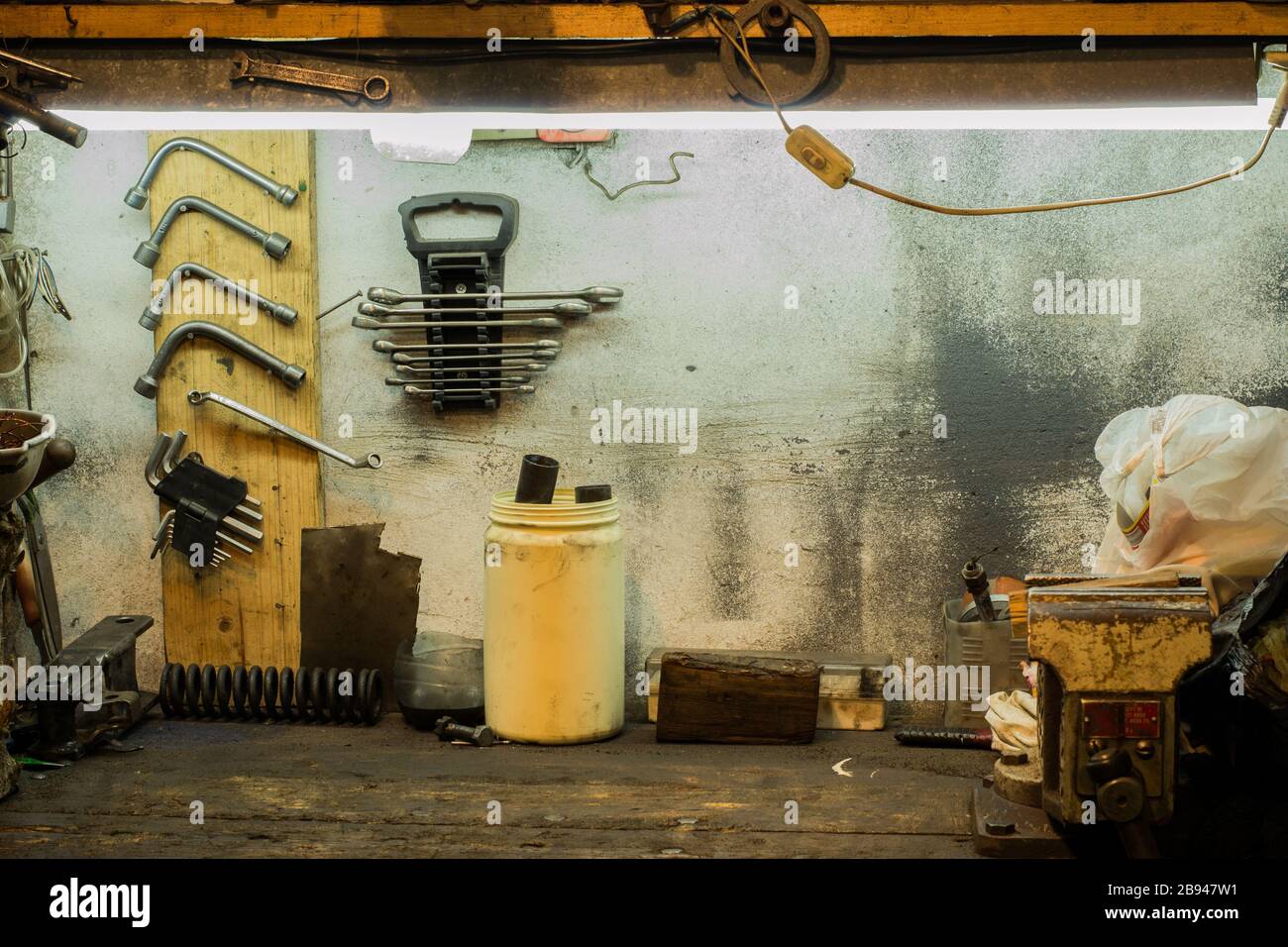 Workbench and old tools in the garage Stock Photo - Alamy
