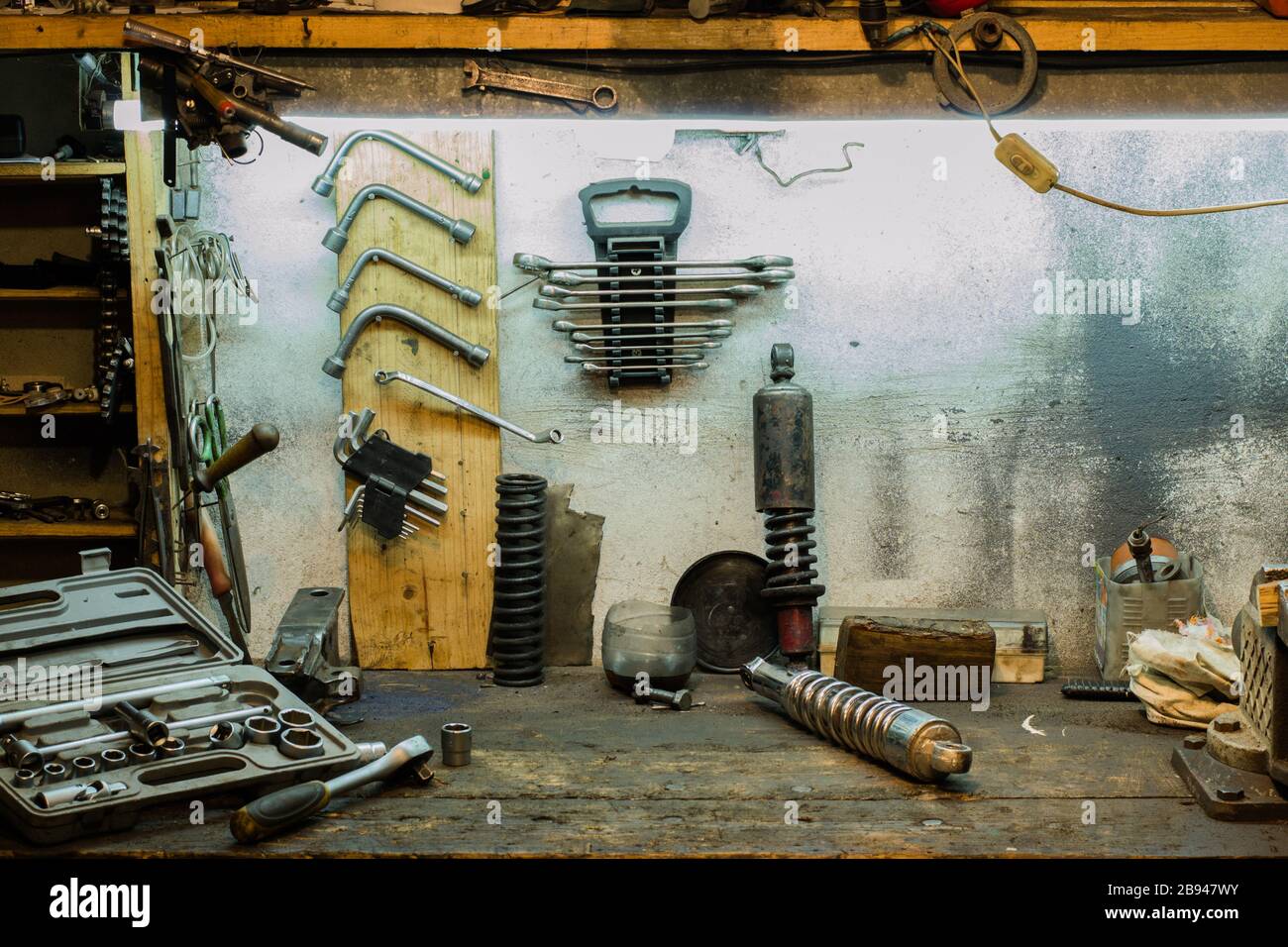 Motorcycle parts and tools on the desktop in the garage Stock Photo - Alamy
