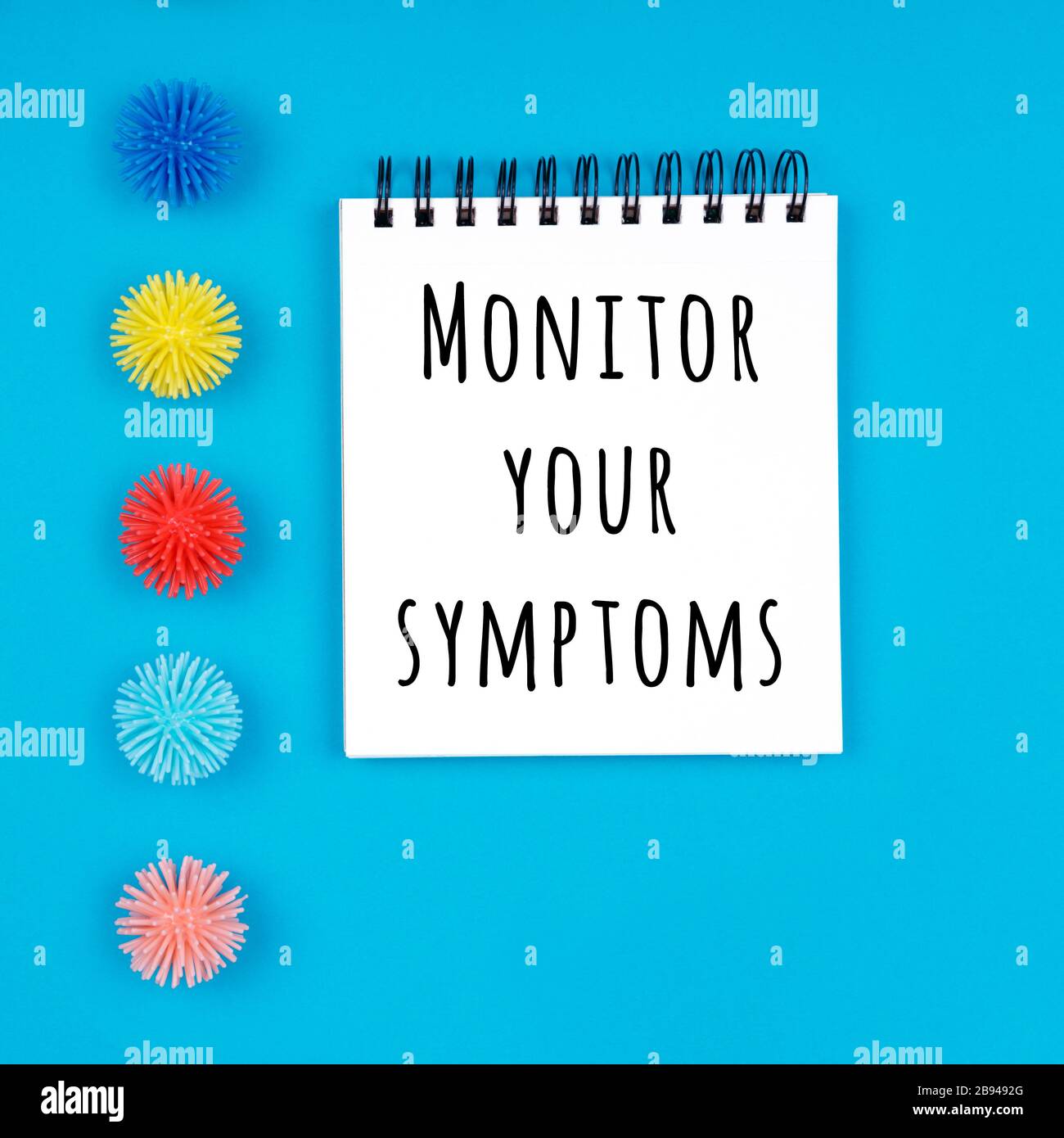 Paper notebook with plastic balls viruses on the blue background with ...