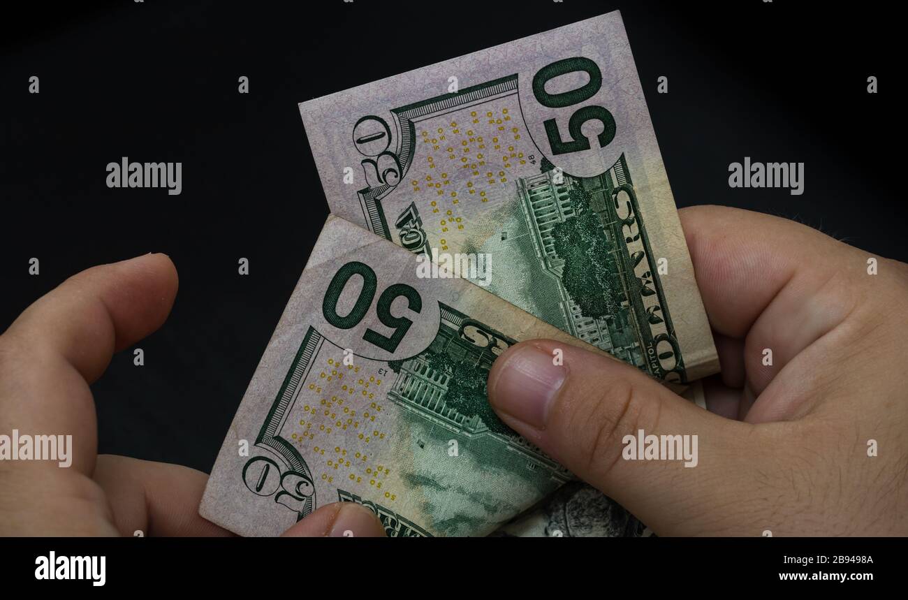 Man counting money, counting dollars close up Stock Photo - Alamy