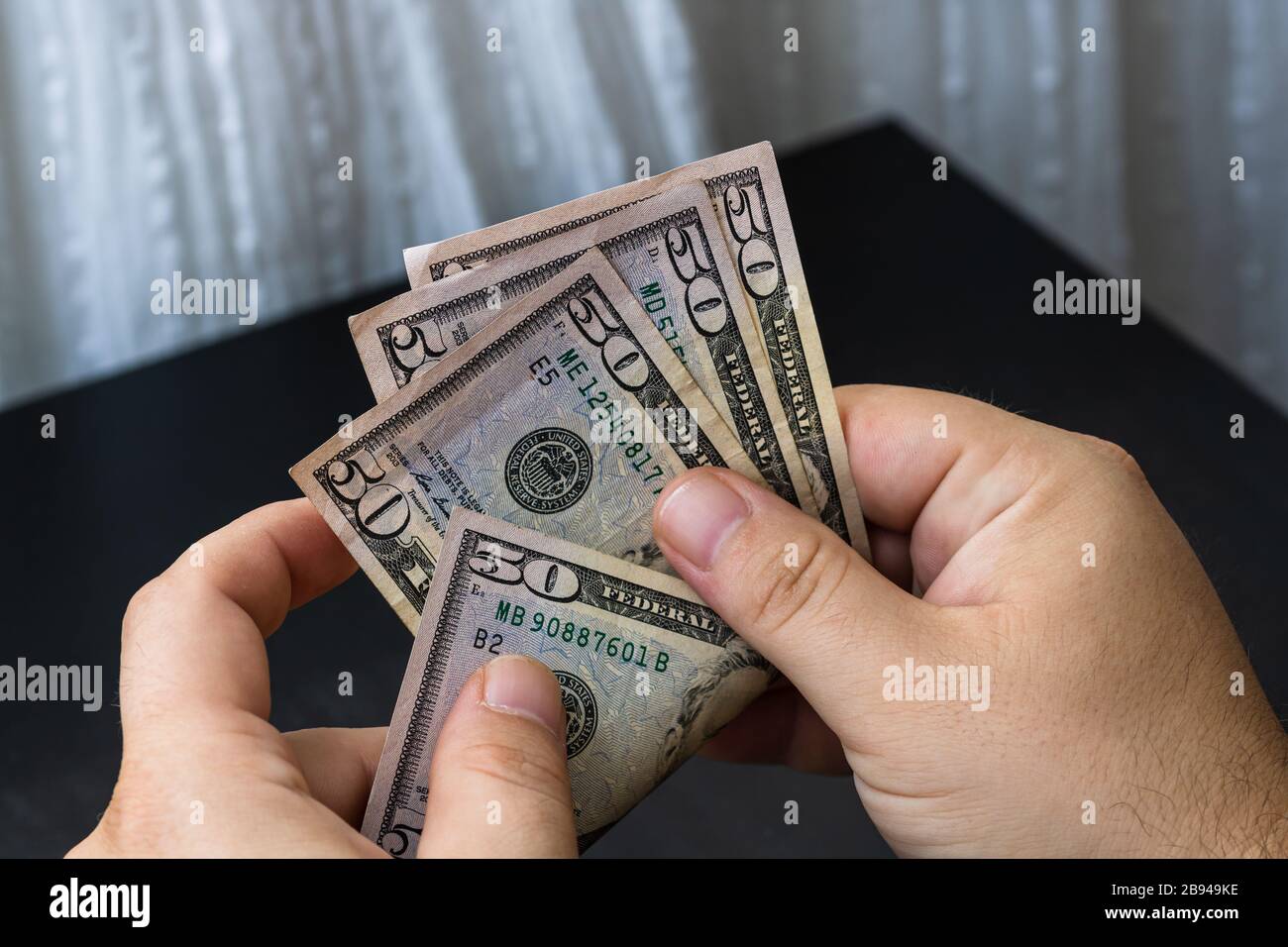 Man counting money, counting dollars close up Stock Photo - Alamy