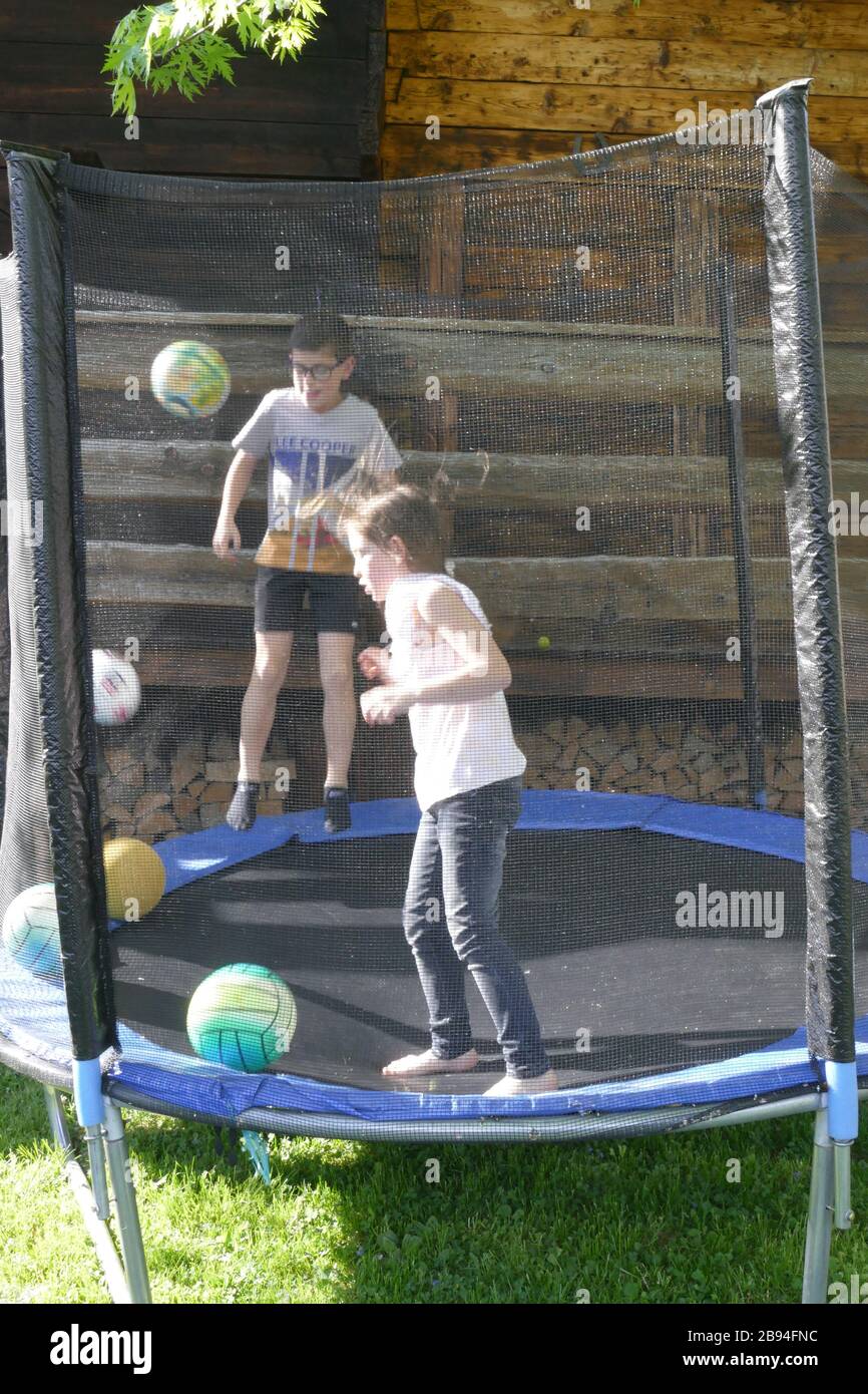 Brother and sister jumping on the trampoline Stock Photo - Alamy