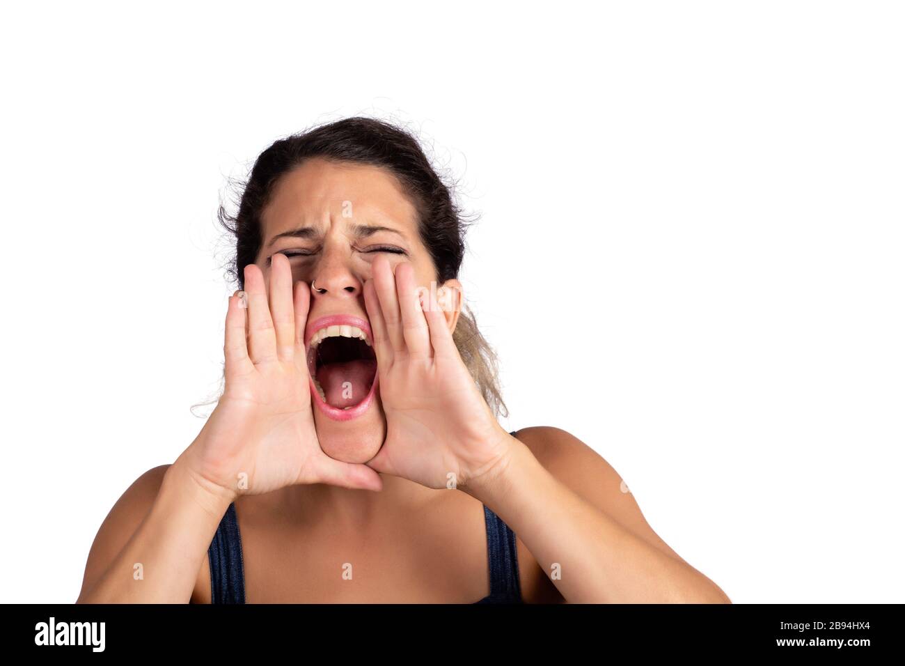 Portrait of beautiful young woman shouting and screaming. Isolated ...