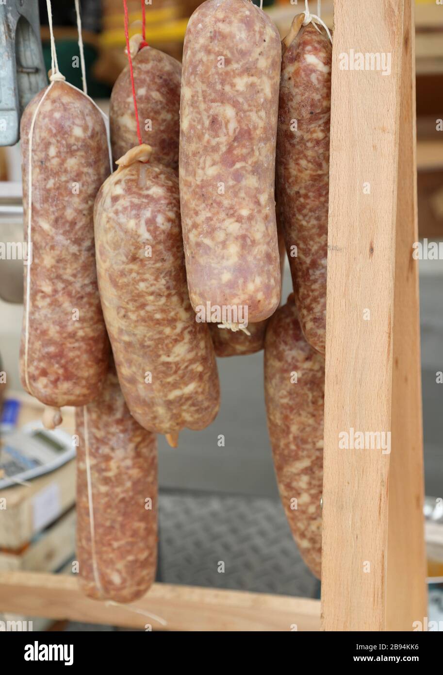 many long pork sausage for sale called Cotechino in Italian language at ...