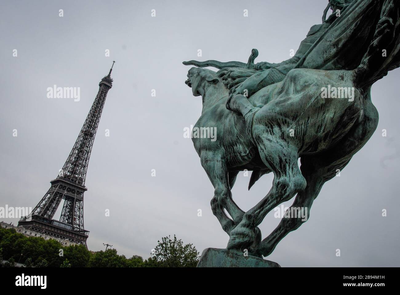 statue attacking the Eiffel Tower Stock Photo - Alamy