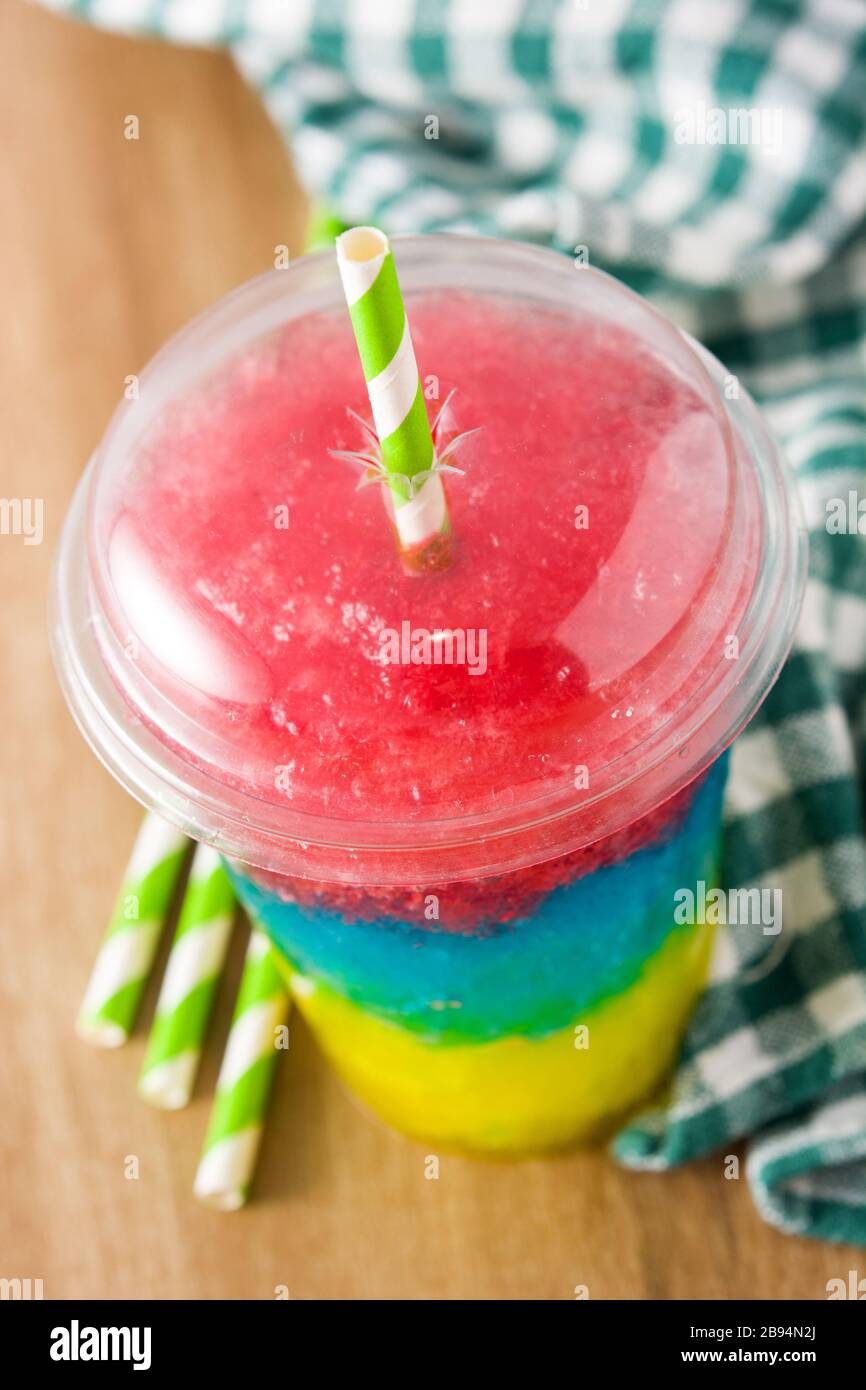 Colorful slushie of differents flavors with straw in plastic cup Stock ...