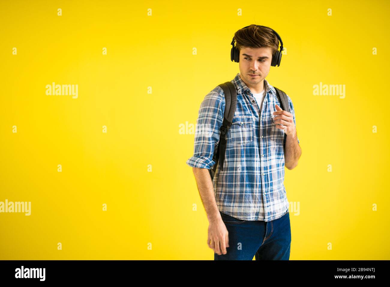 modern and cool young student listening music on the way to school on ...