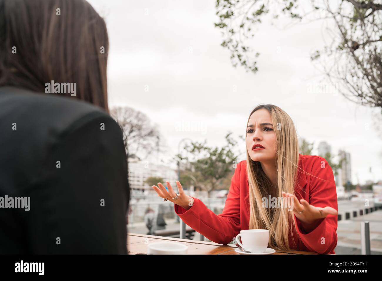 Portrait of two angry friends having a serious conversation and ...