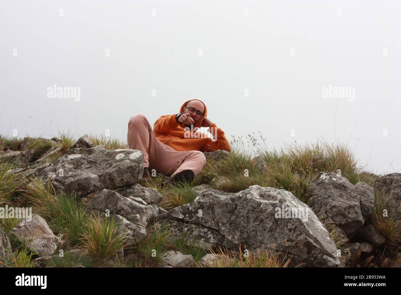 bald boy sprawled on the ground in nature with the fog behind you and ...