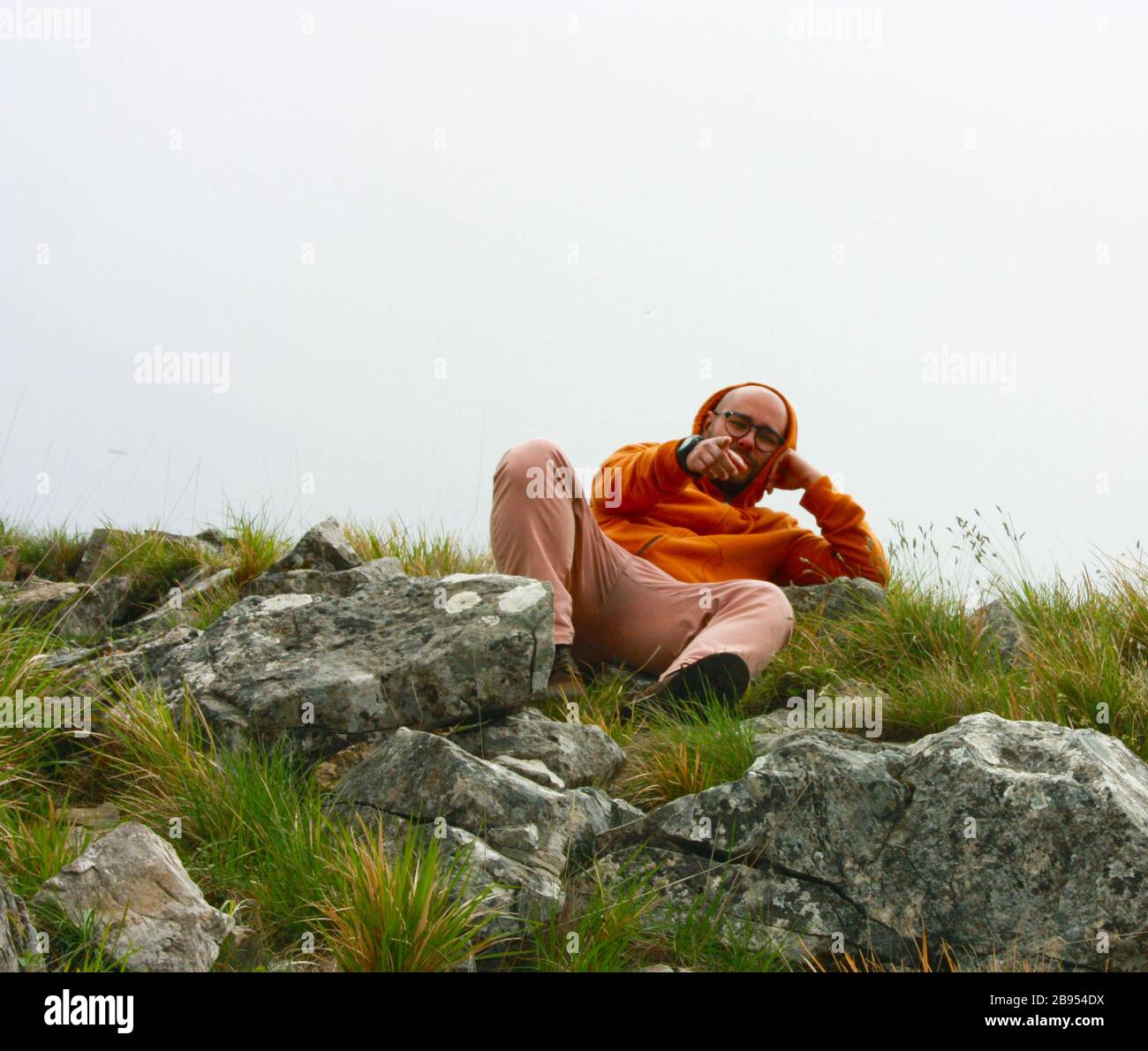 bald boy sprawled on the ground in nature with the fog behind you and ...