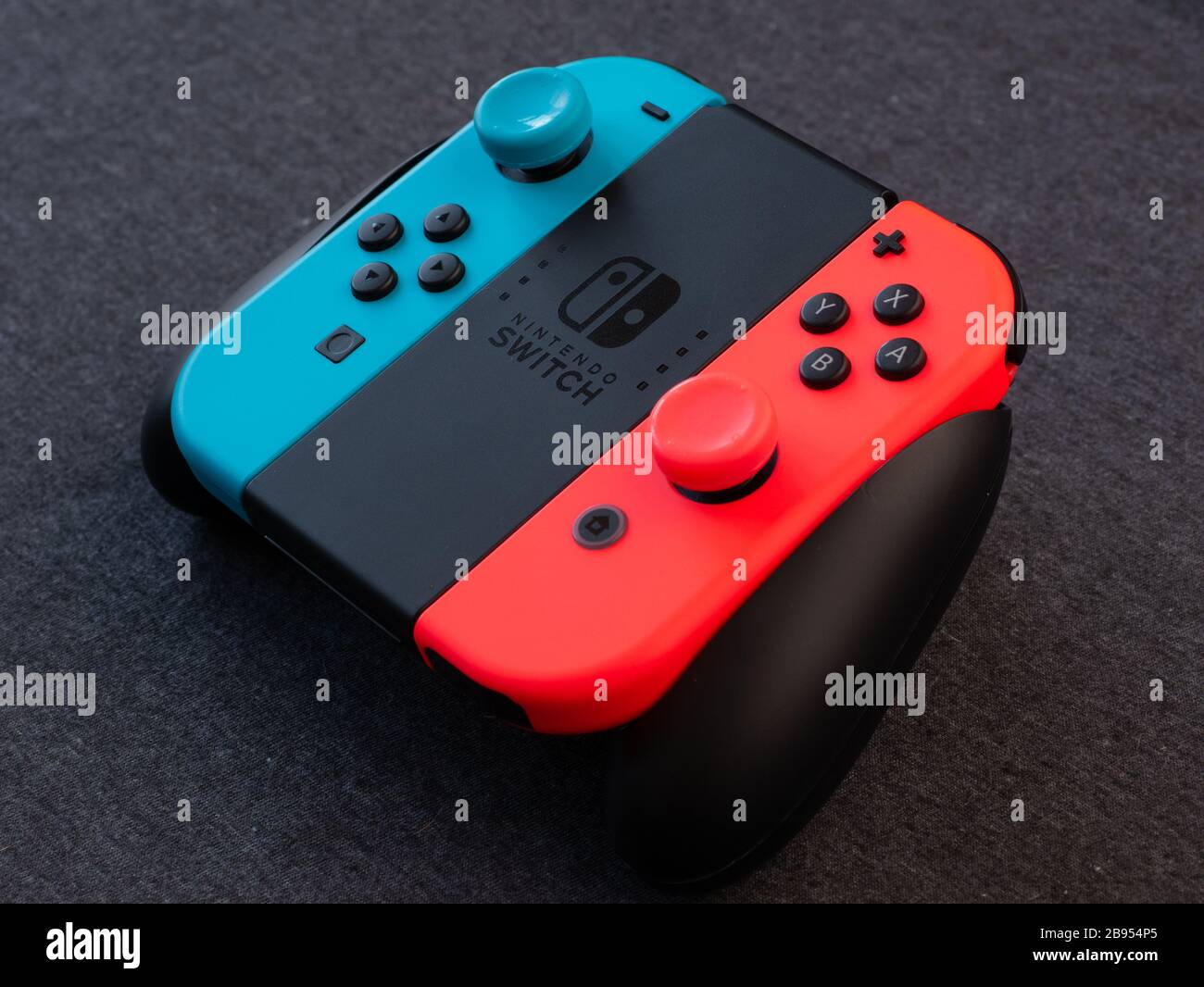 UK, March 2020: Nintendo Switch Joy Con Grip controller red and blue ...