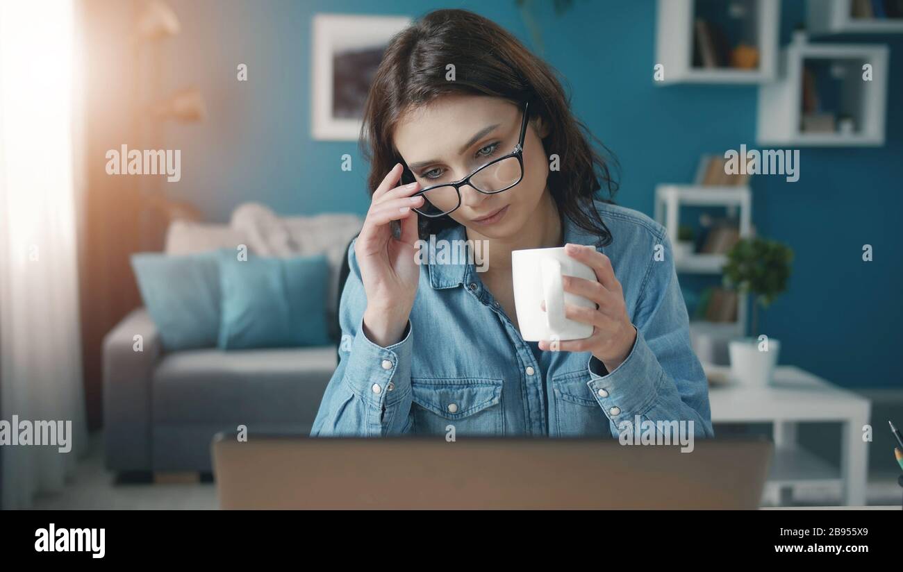 Focused woman looking laptop screen Stock Photo - Alamy