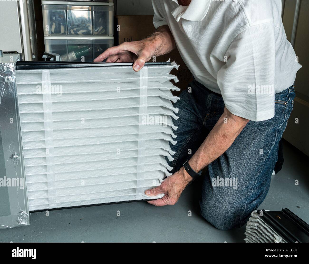 Senior caucasian man checking a clean folded air filter in the HVAC ...
