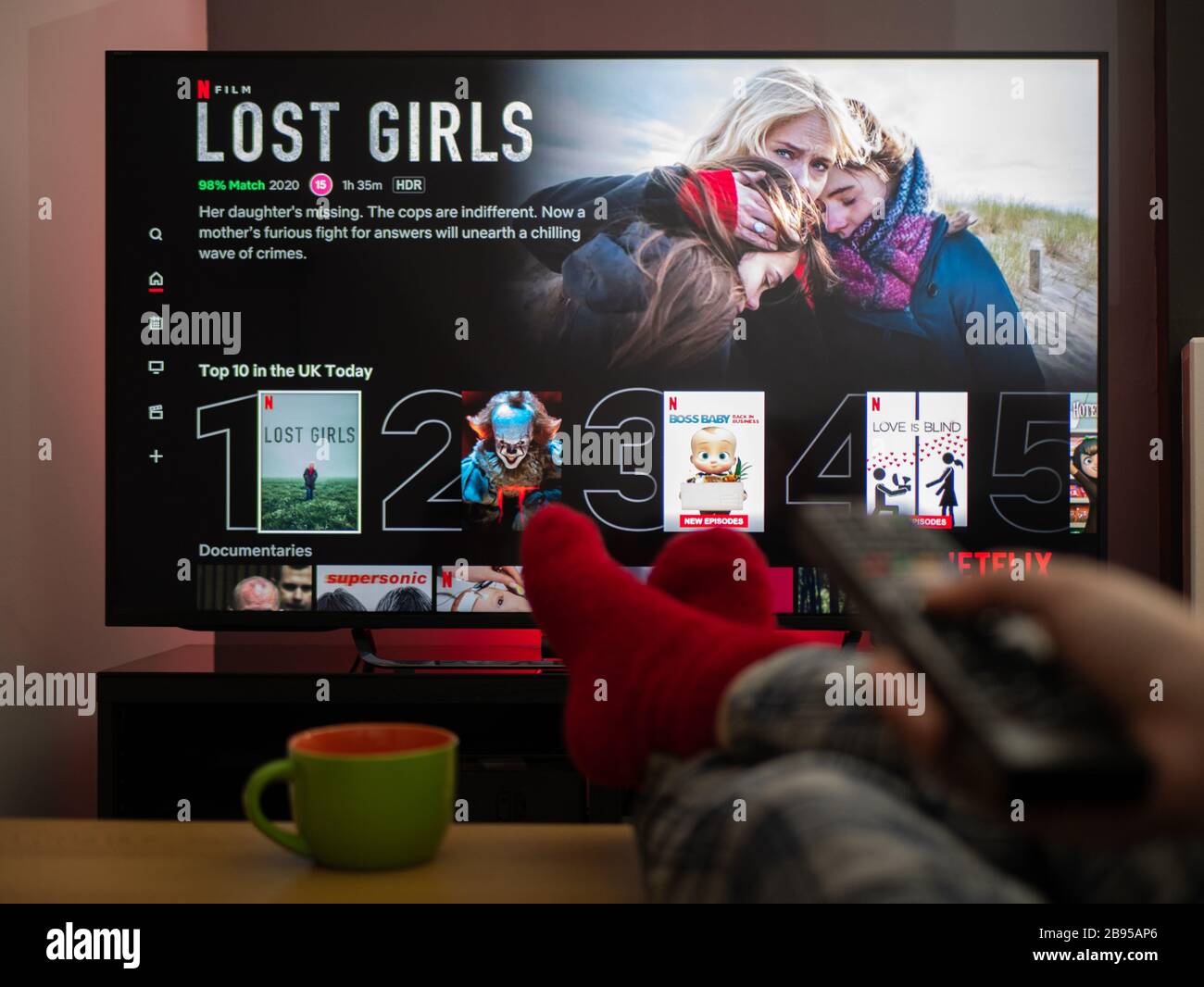 UK, March 2020: TV Television Netflix menu with feet up at home Stock ...