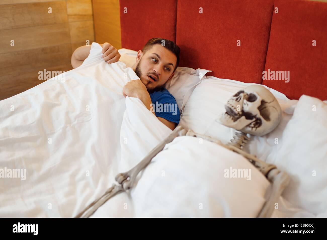 Man and human skeleton sleeping in the bed Stock Photo - Alamy