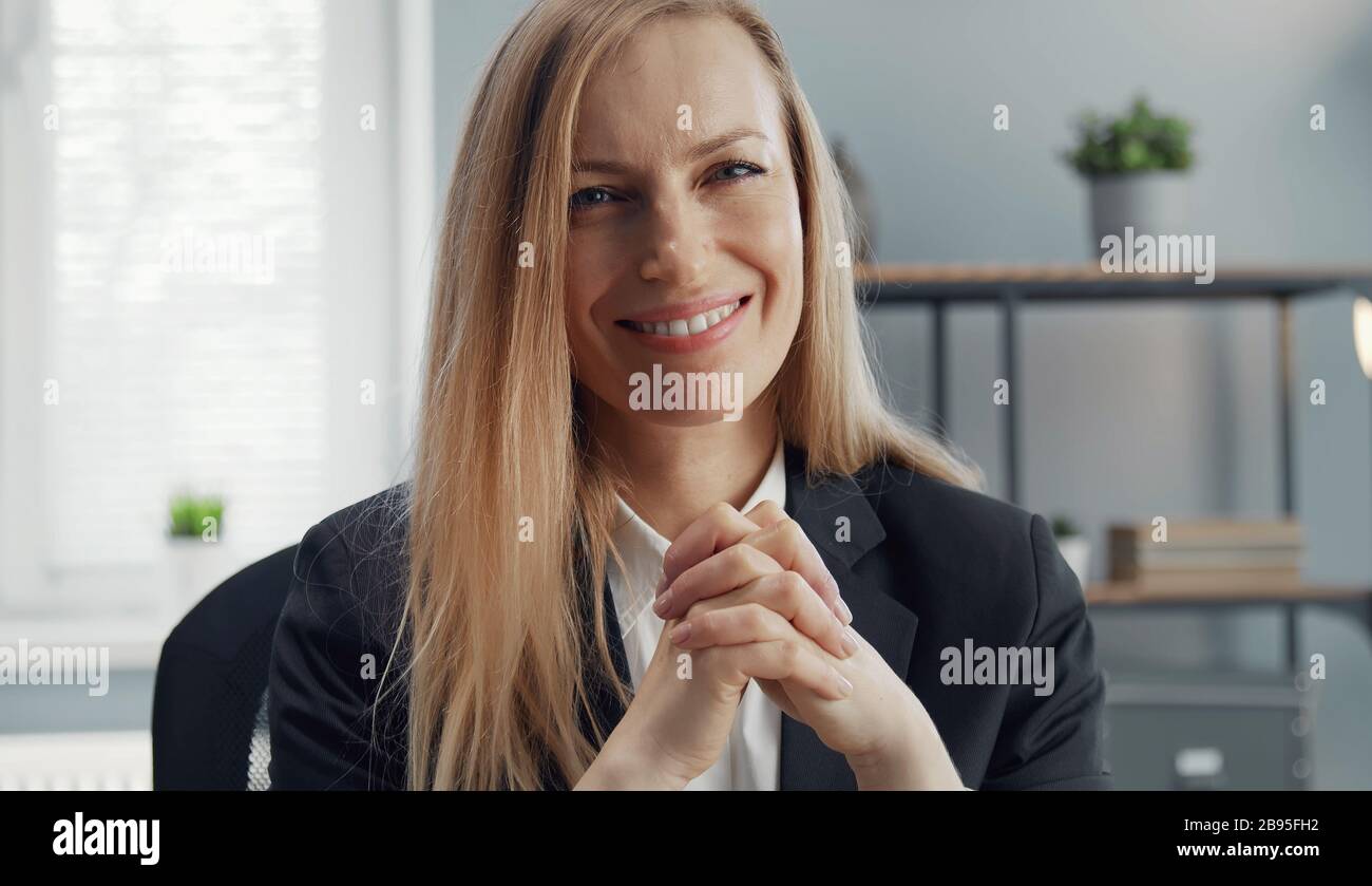 Smiling blond business lady portrait Stock Photo - Alamy