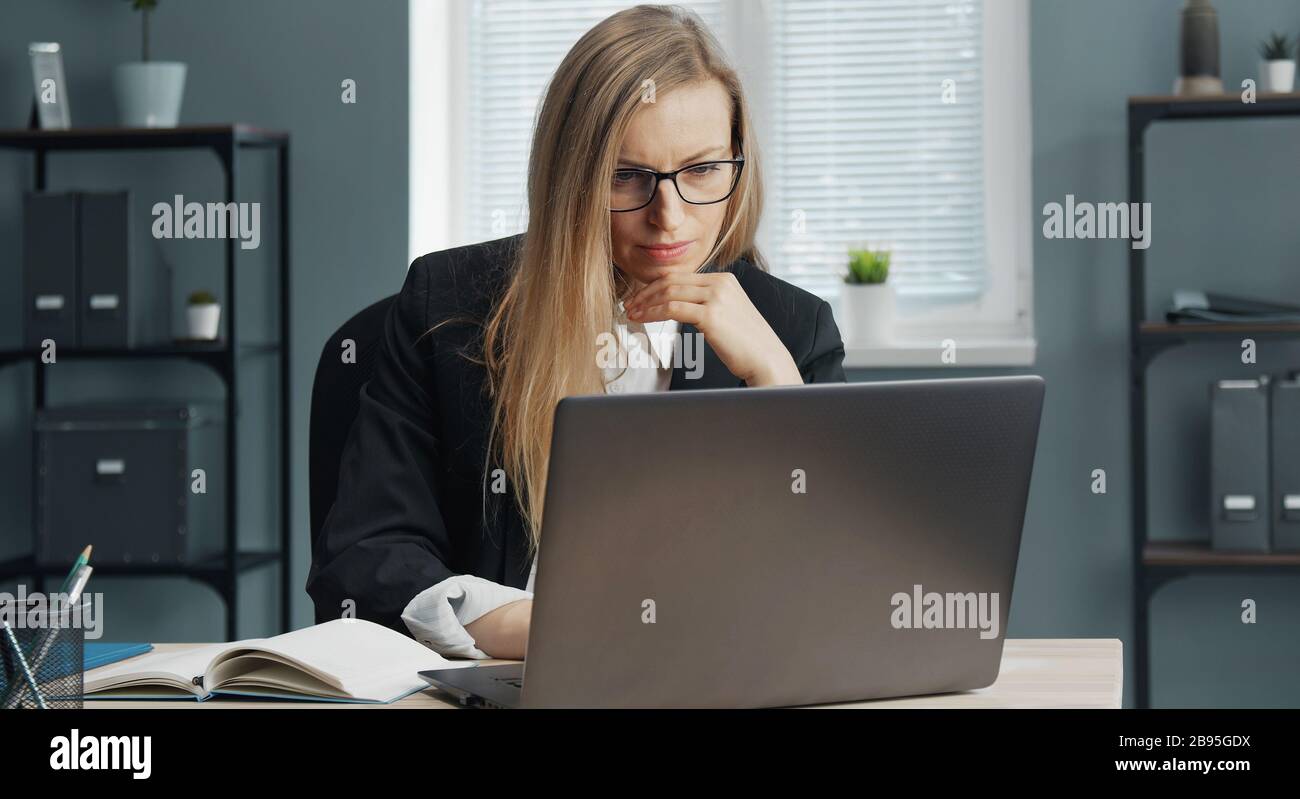 Businesslady working laptop in office Stock Photo - Alamy