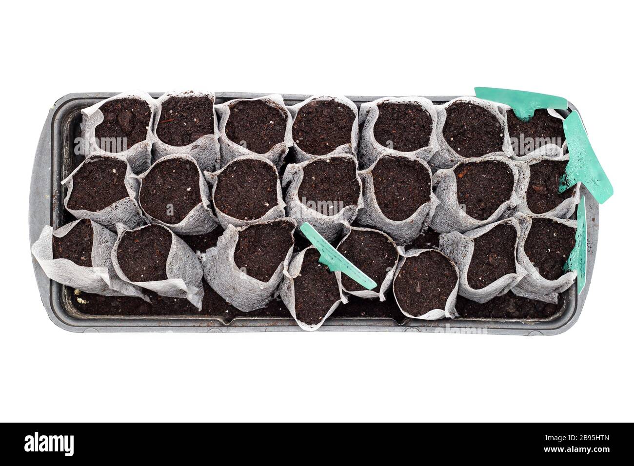 White woven fabric bags with soil in a black plastic container against ...