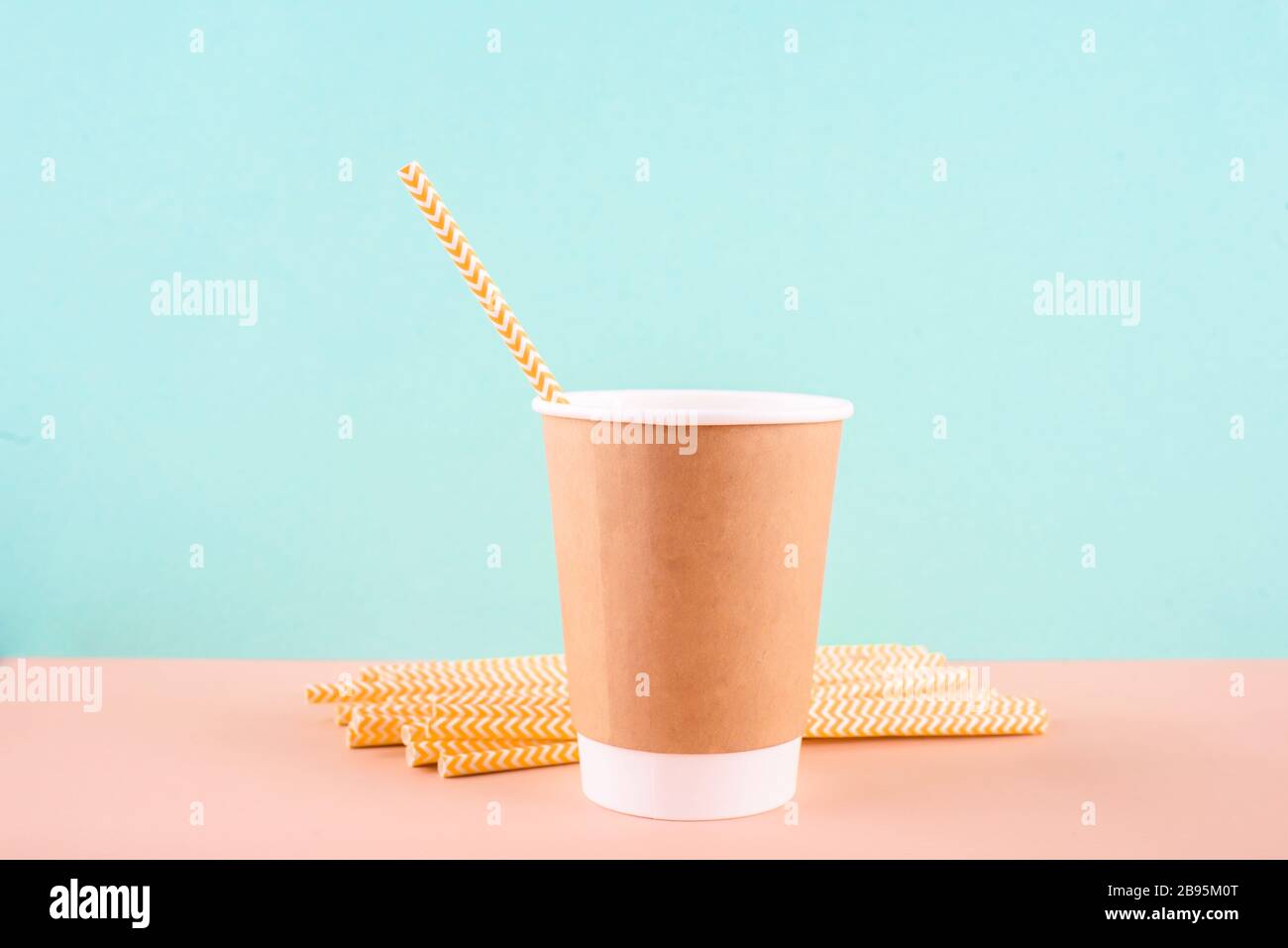 Paper glass with drinking tubes. Eco utensils on a light background ...