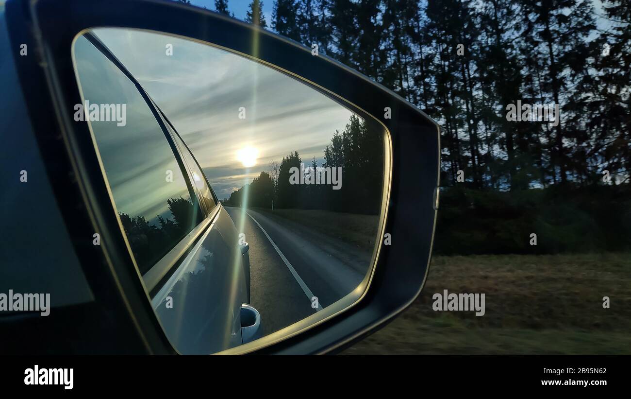 Reflection of the highway in a car mirror. Toned photo. Road travel ...