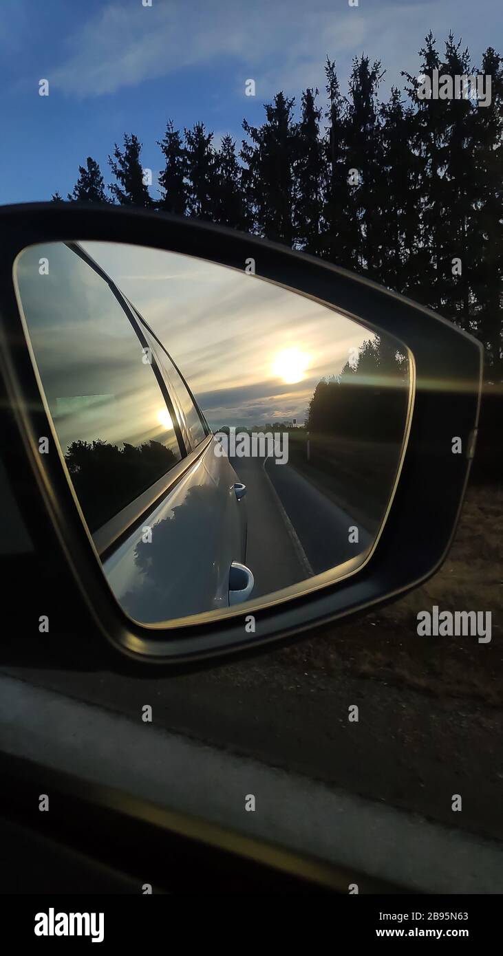 Reflection of the highway in a car mirror. Toned photo. Road travel ...