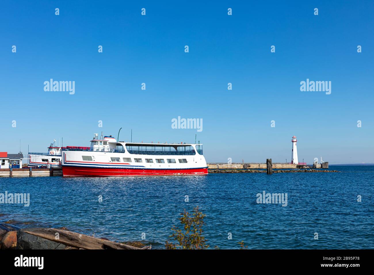 Ferry at dock, in St Ignace with the Wawatam Lighthouse in the ...