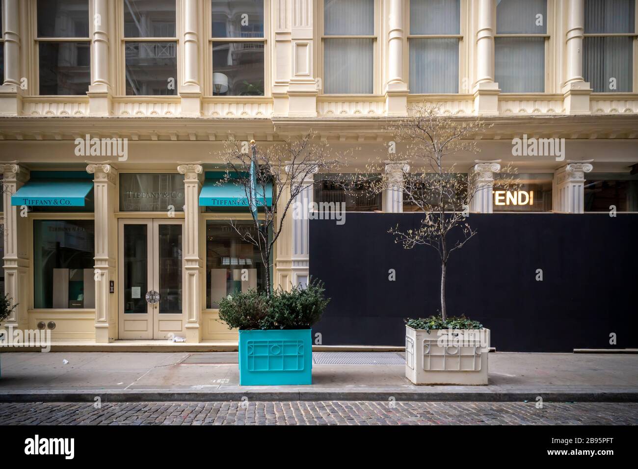Luxury retailer Fendi boards up their store, next to a closed Tiffany ...