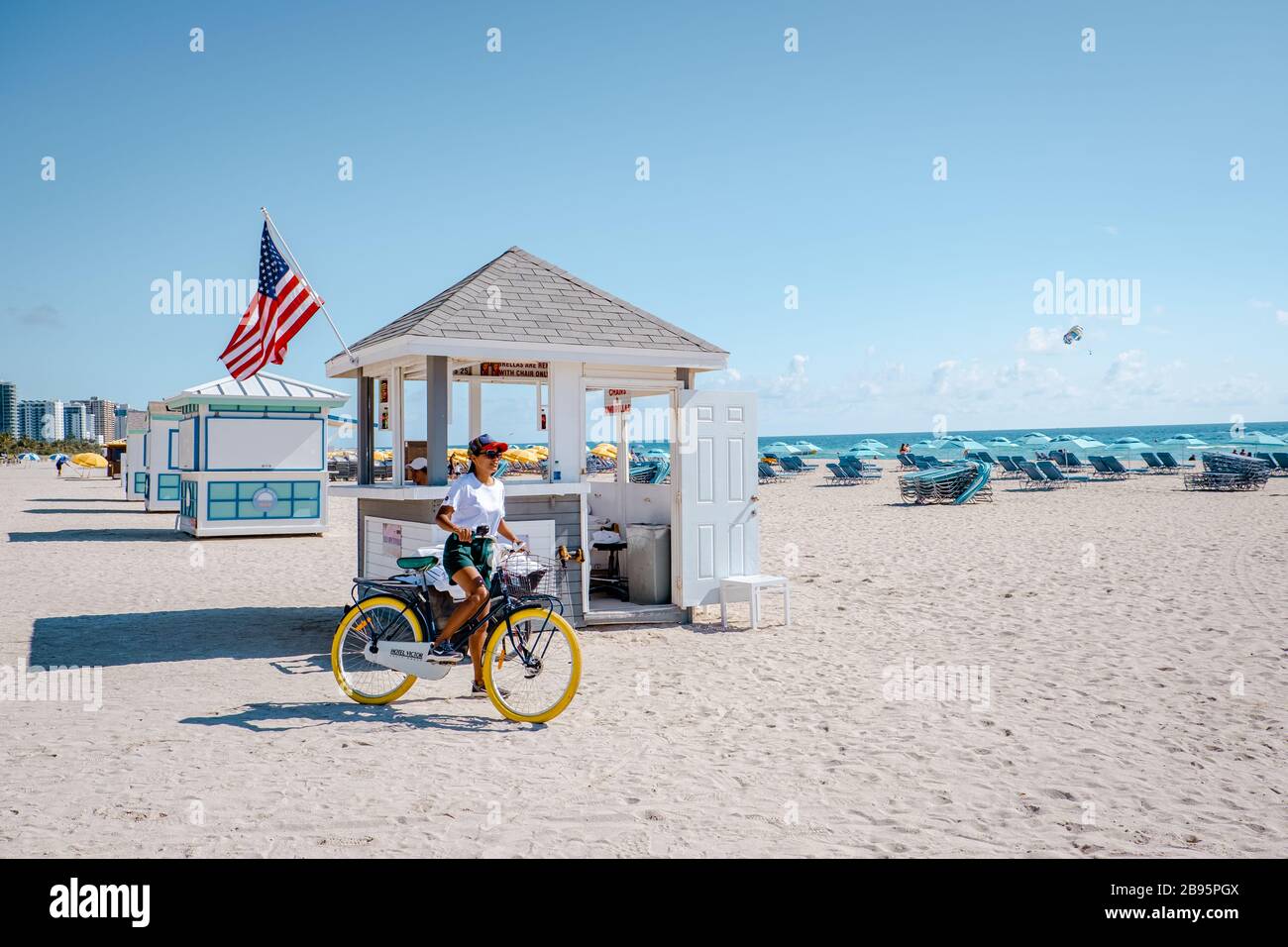 Miami beach Florida, young men on the beach with colorful lifeguard hut ...