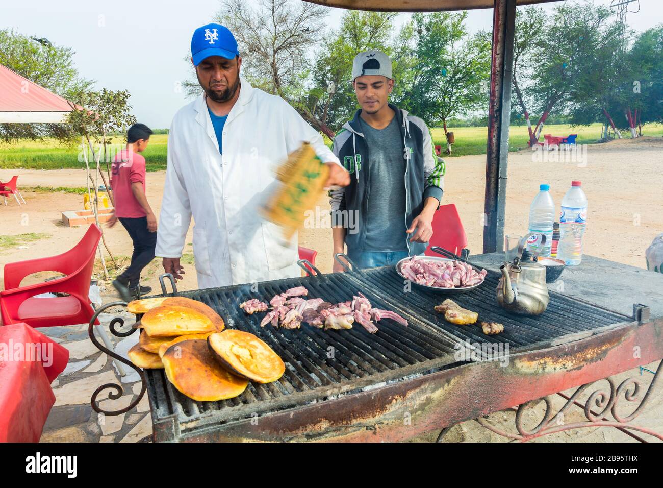 Cooking lamb in a road food stall Stock Photo - Alamy