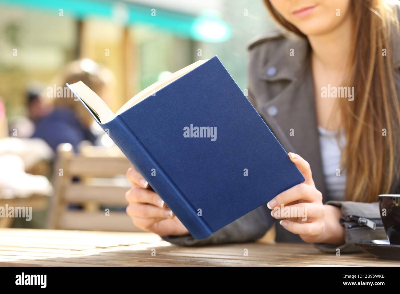 Hands holding book cover hi-res stock photography and images - Alamy