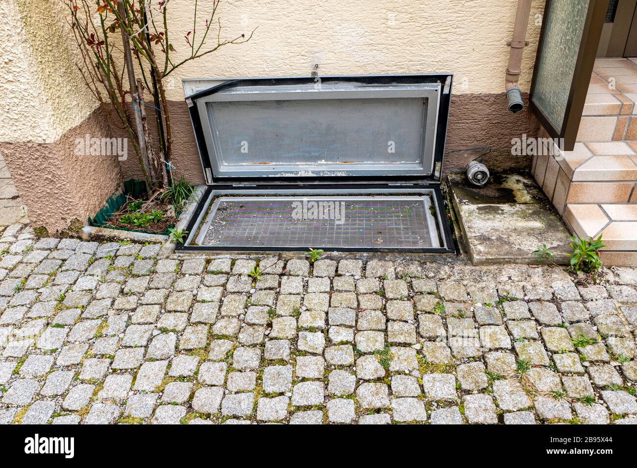 Basement window with insect screen embedded in the floor Stock Photo ...