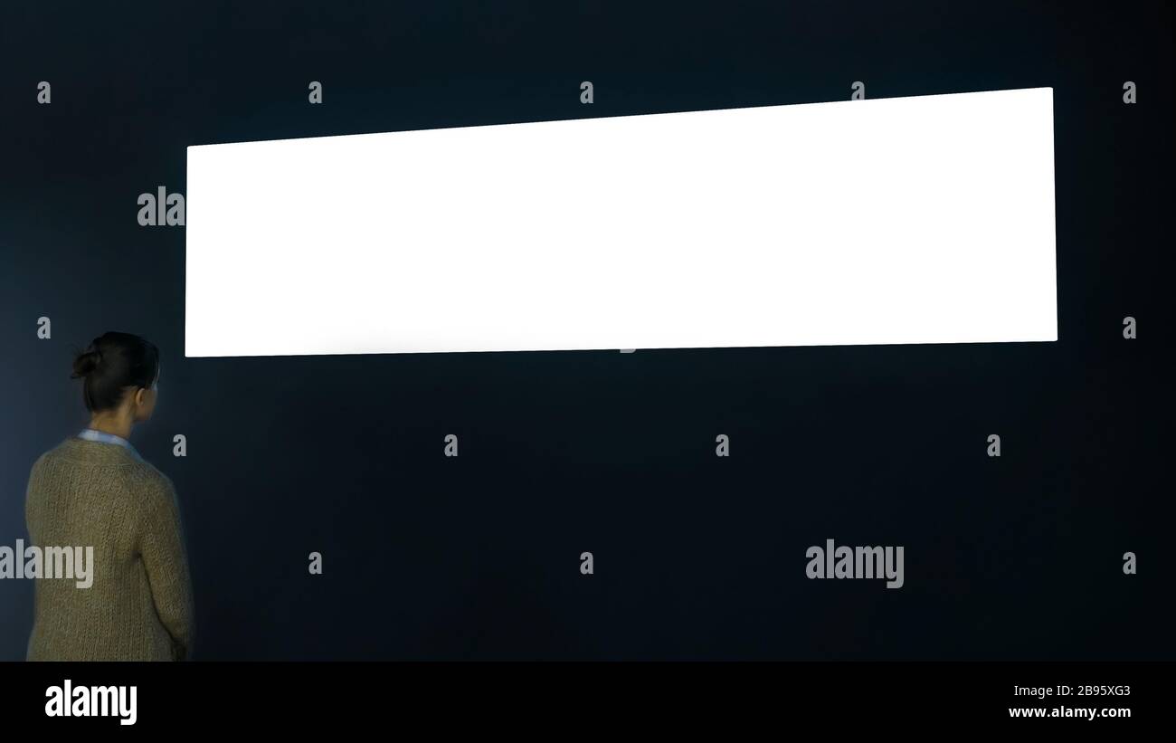 Woman looking at large blank white screen - isolated concept Stock ...