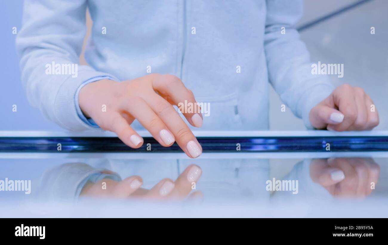 Woman using multimedia touchscreen display of interactive kiosk Stock ...