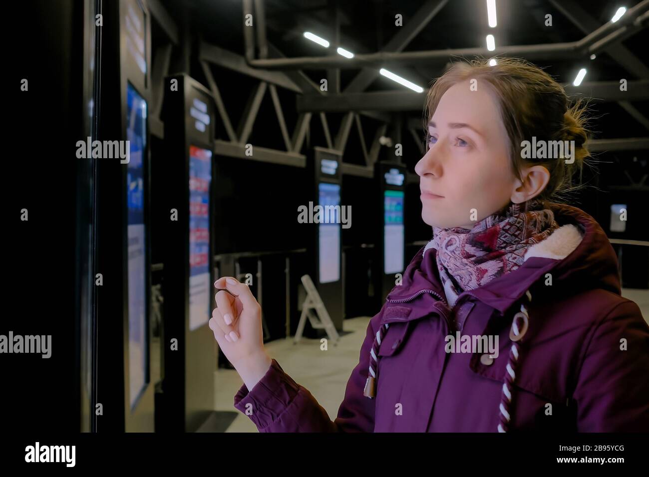 Woman using interactive touchscreen display of electronic multimedia ...