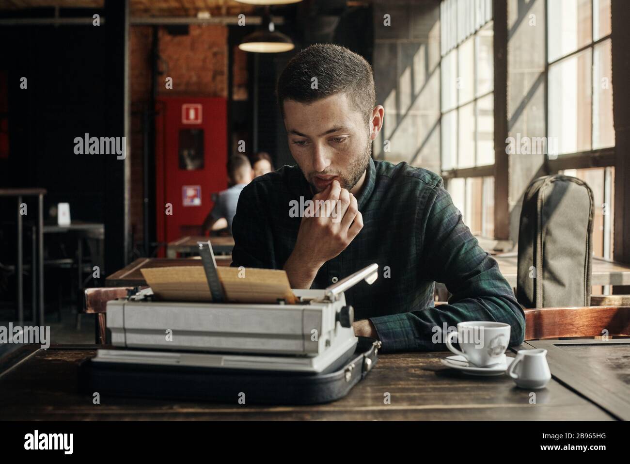 Young man writing on old typewriter Stock Photo - Alamy