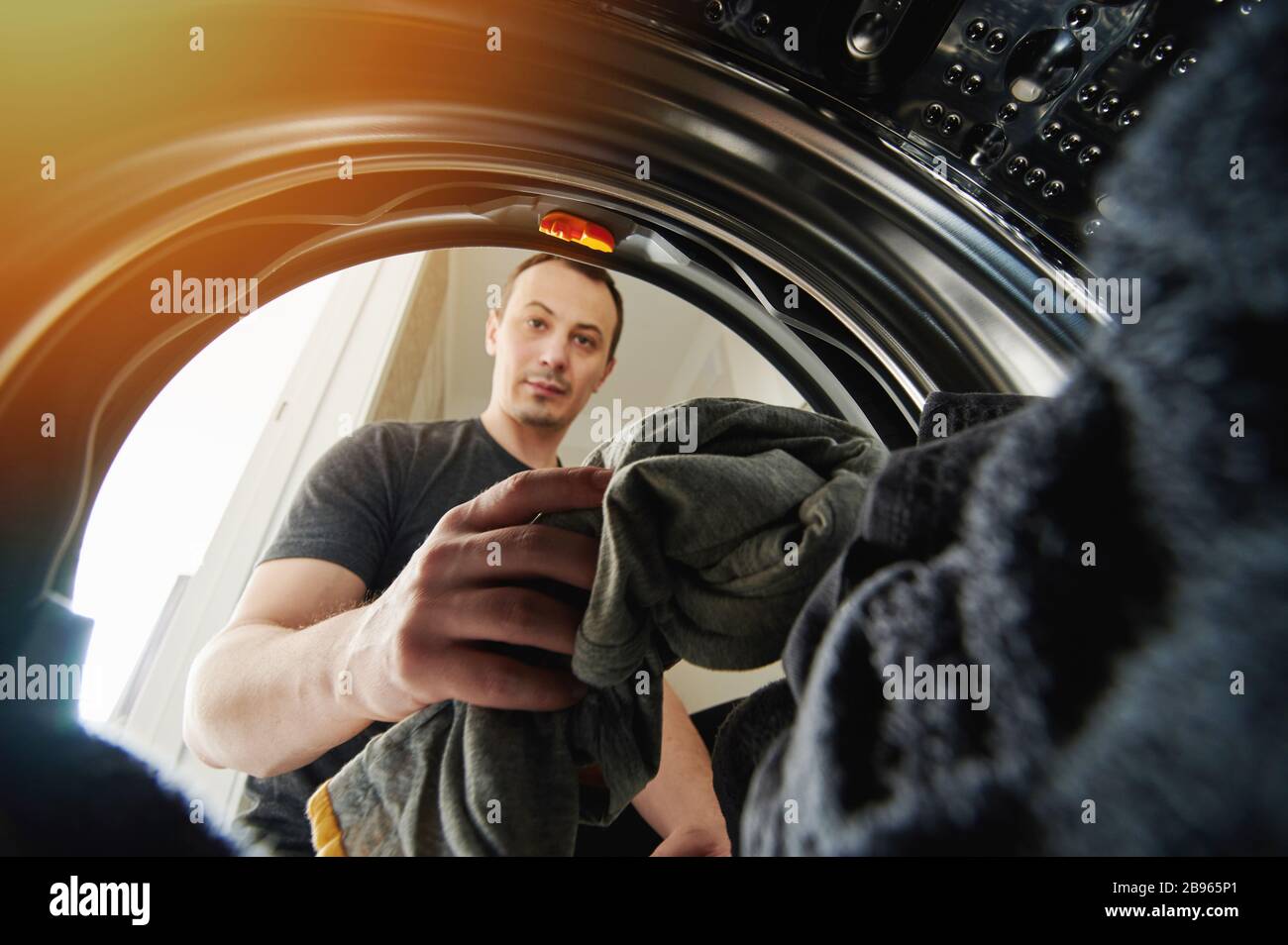 Loading washing machine hi-res stock photography and images - Alamy
