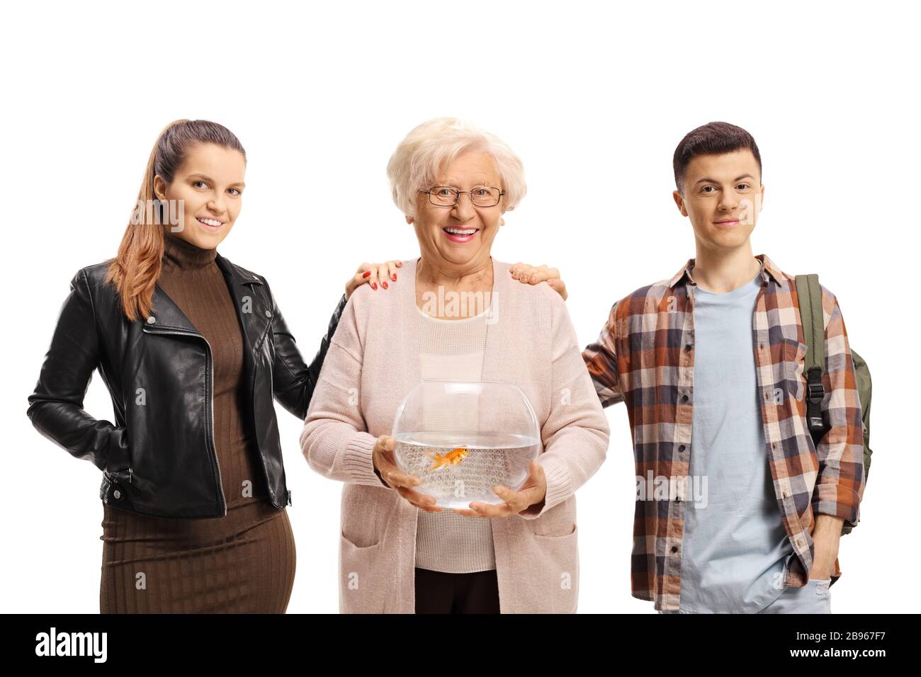 Young guy and girl posing with a senior woman holding a bowl with a ...