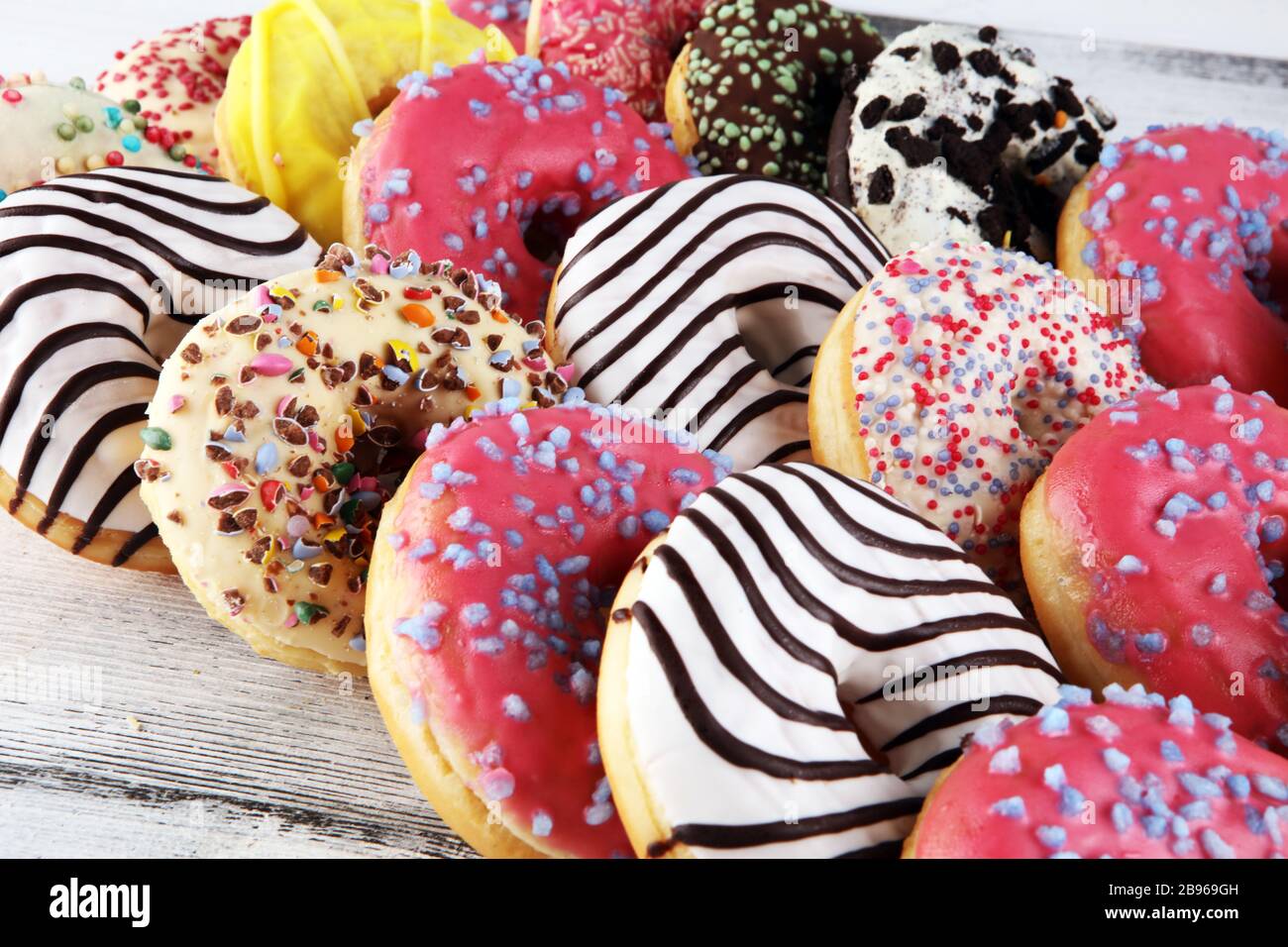 assorted donuts with chocolate frosted, pink glazed and sprinkles ...