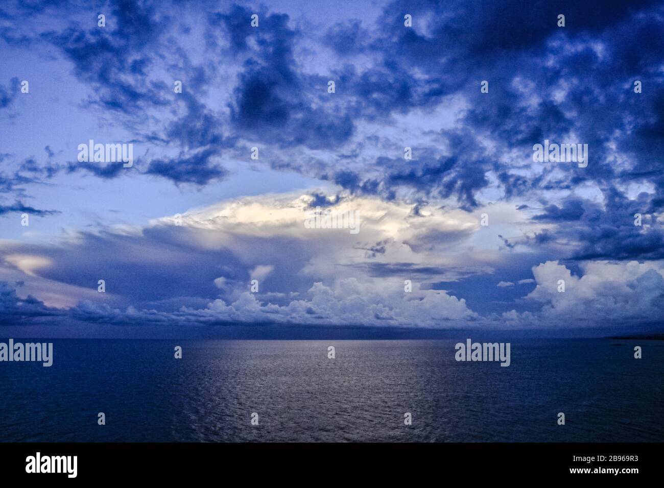 Unique bodies of cumulus thunderstorm clouds over ocean waters horizon ...